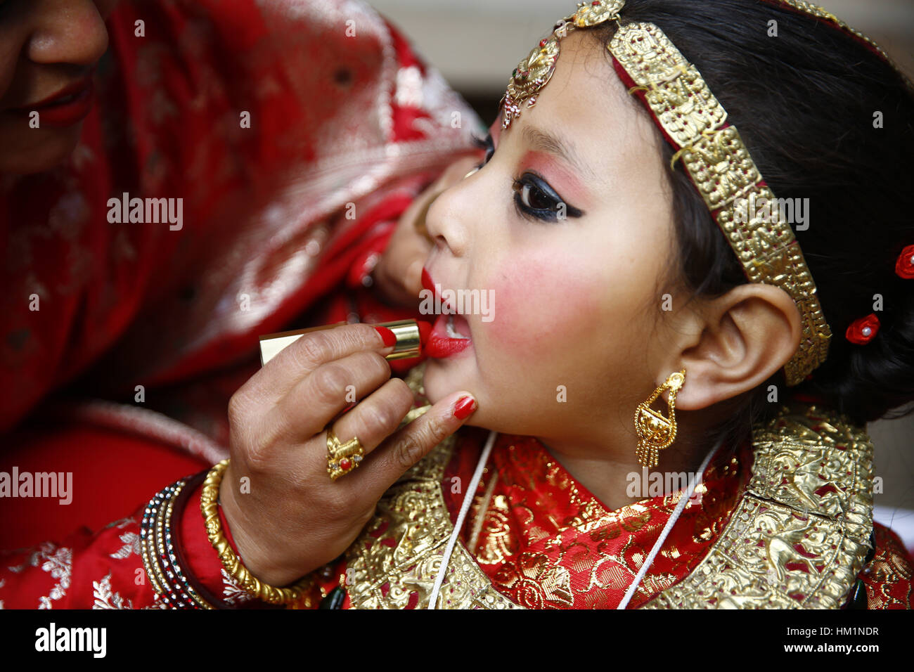 Kathmandu, Nepal. 1st Feb, 2017. A mother applies makeup on her ...