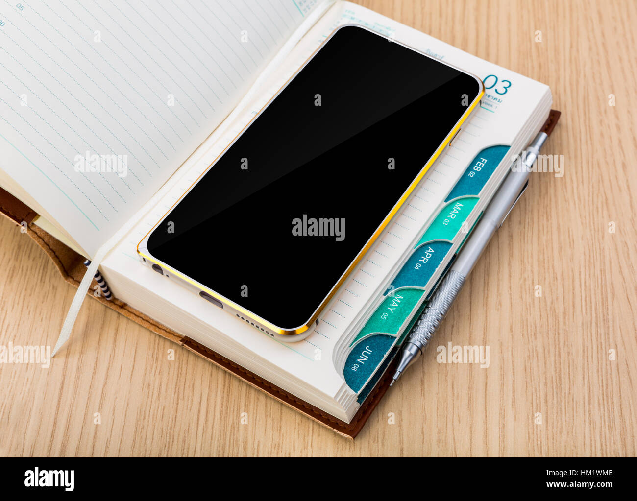 Modern mobile phone and Year business project planner book with pen on ...