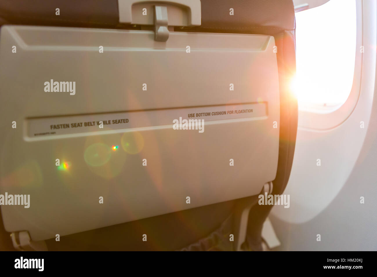 Seated sign on airplane fasten seat belt Stock Photo - Alamy