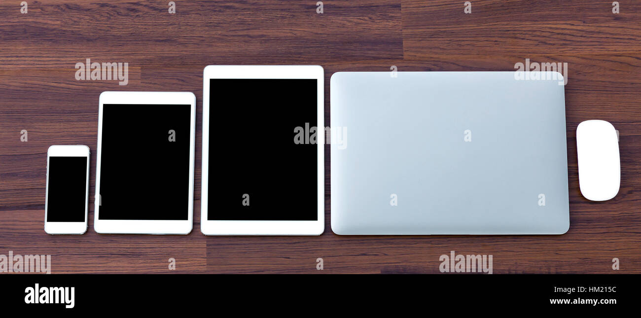 laptop with tablet and smart phone on table Stock Photo - Alamy