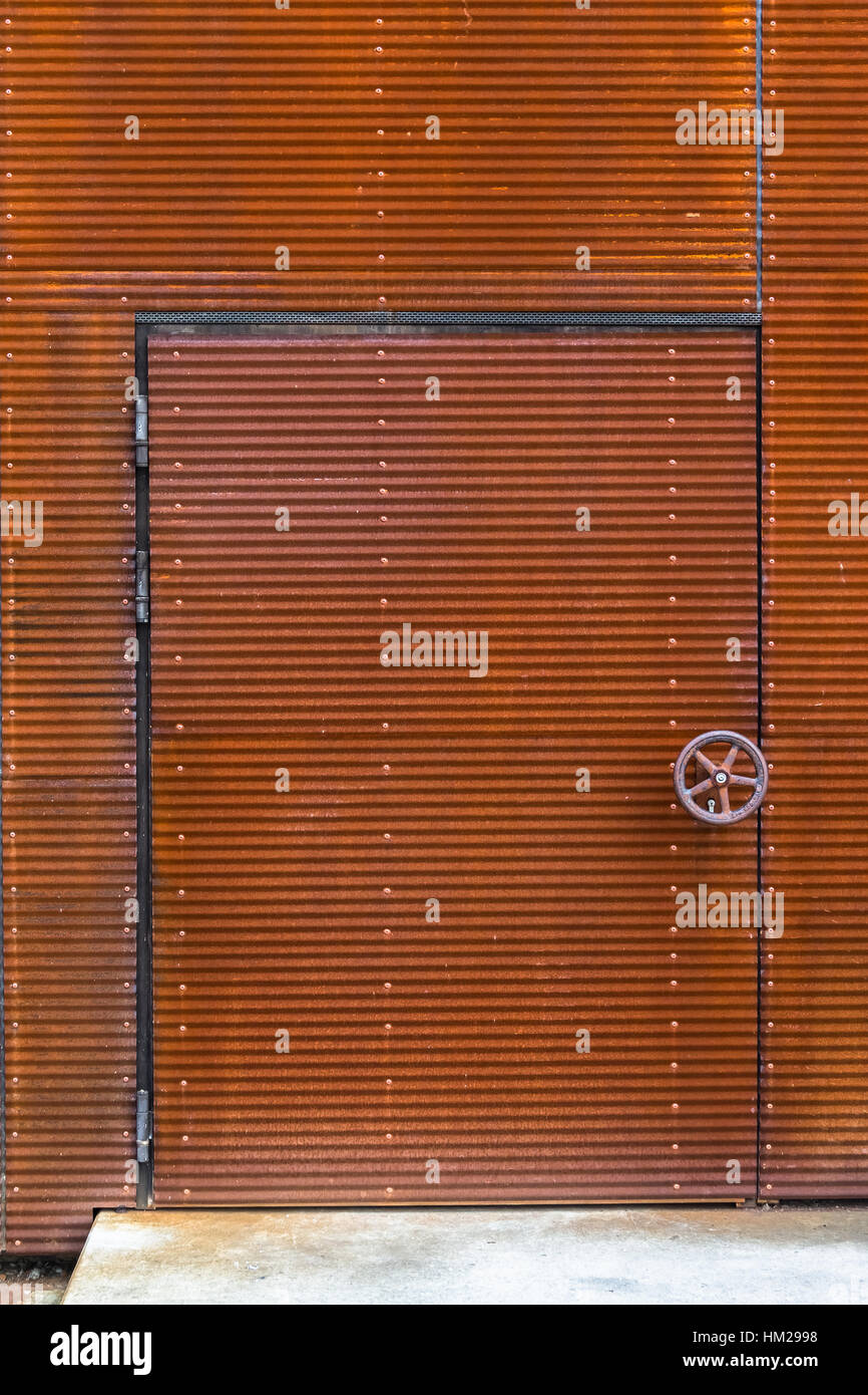 Massive Rusty Door on a Modern Building Stock Photo - Alamy