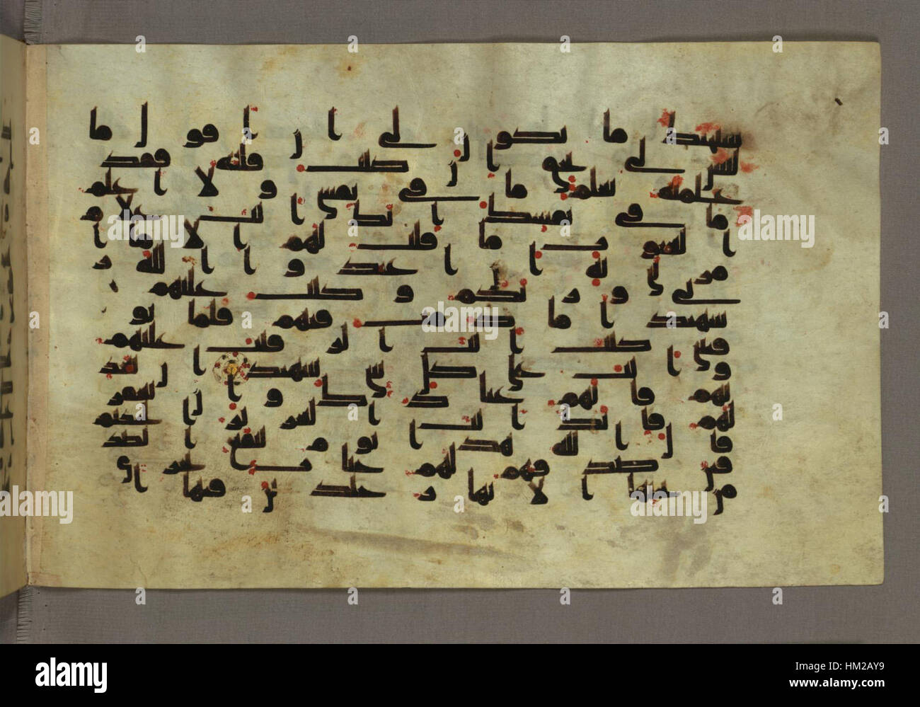 A full-page folio featuring Kufic script, an early form of Arabic ...