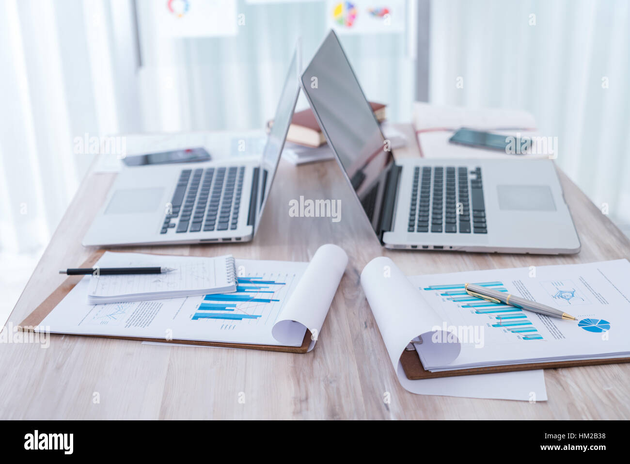 Financial charts on the table with laptop Stock Photo - Alamy