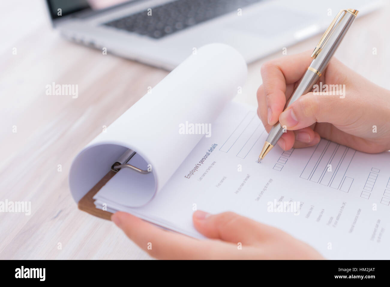 Hand with pen over application form Stock Photo - Alamy