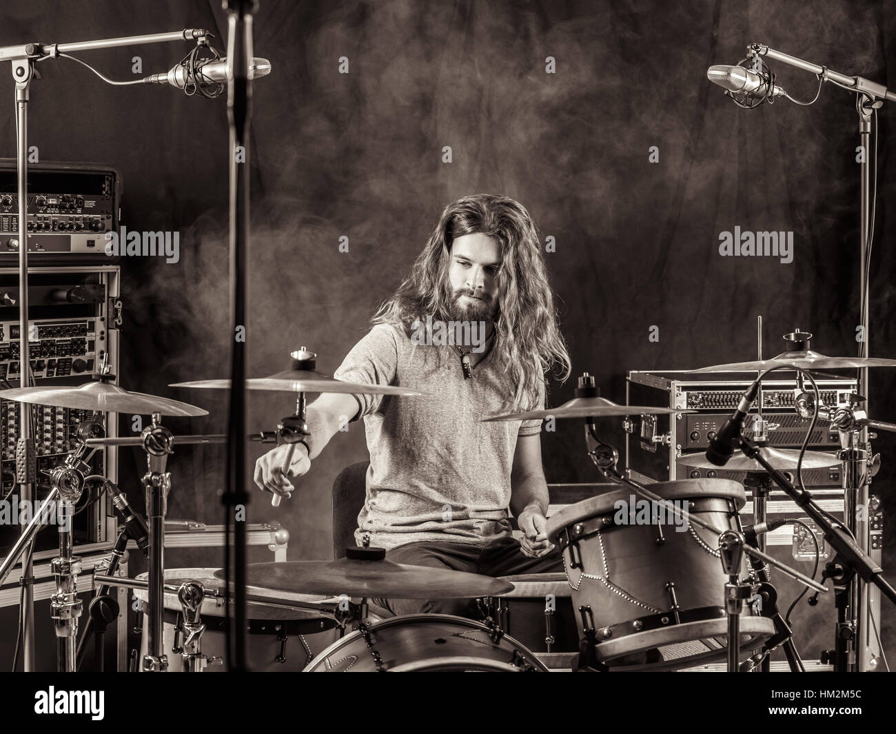 Photo of a young male drummer with long hair playing his drum set Stock ...