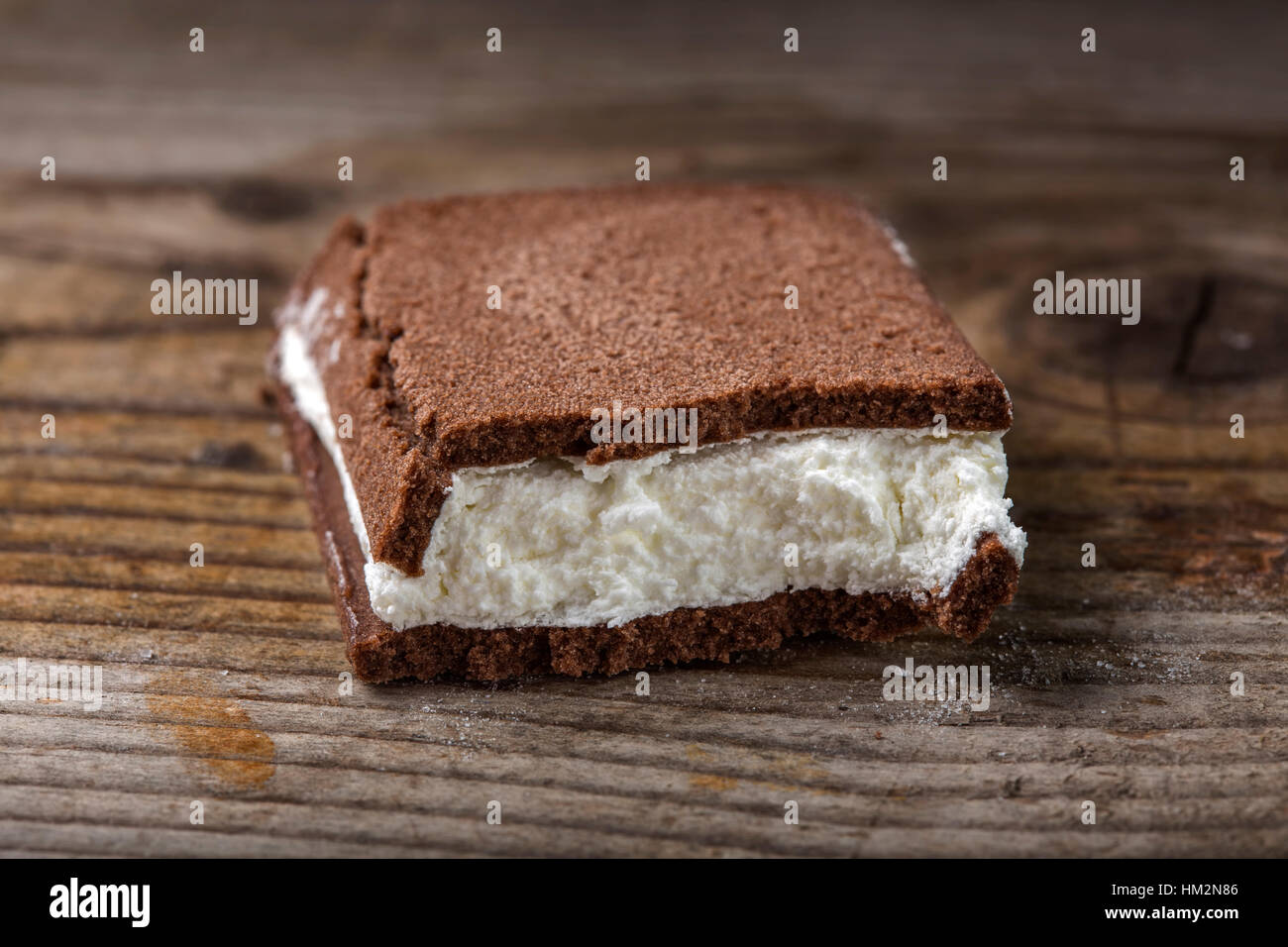 Close up of one broken cake filled with milk and yogurt cream over ...