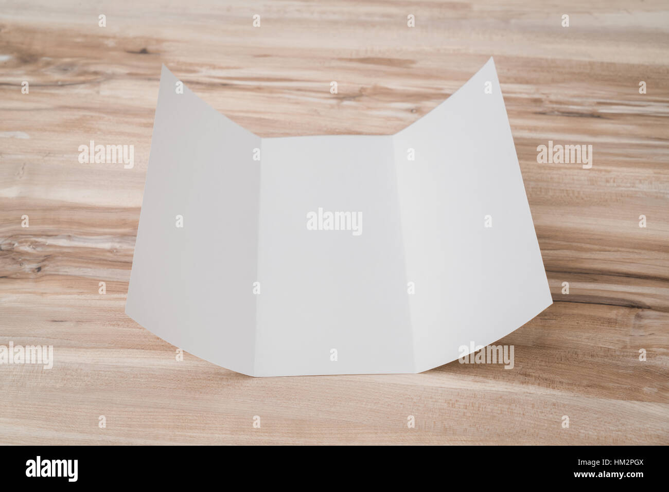 Trifold white template paper on wood texture Stock Photo - Alamy