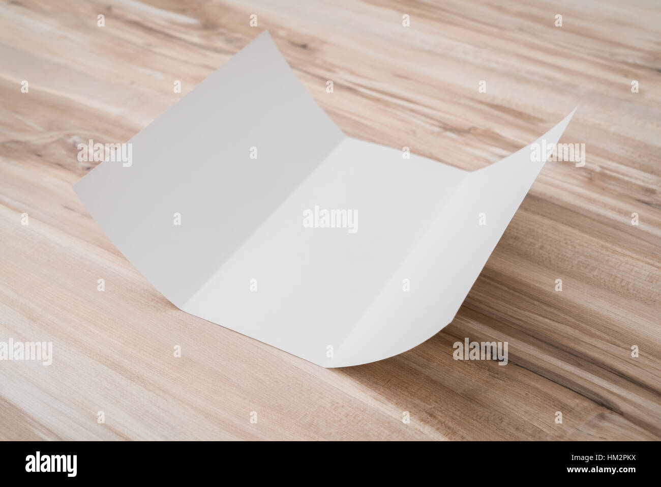Trifold white template paper on wood texture Stock Photo - Alamy