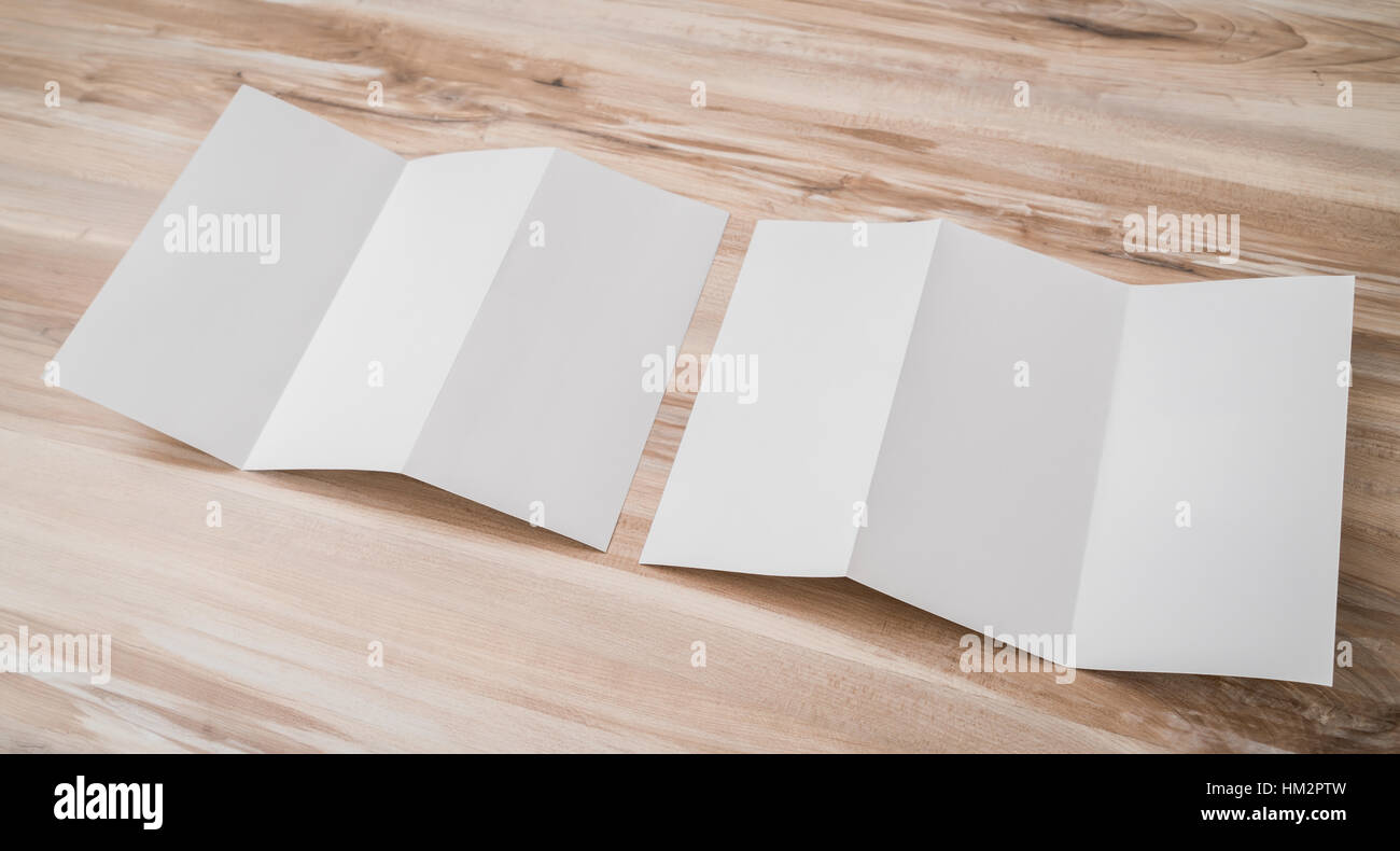 Trifold white template paper on wood texture Stock Photo - Alamy