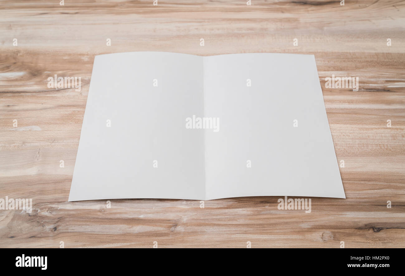 Bifold white template paper on wood texture Stock Photo - Alamy