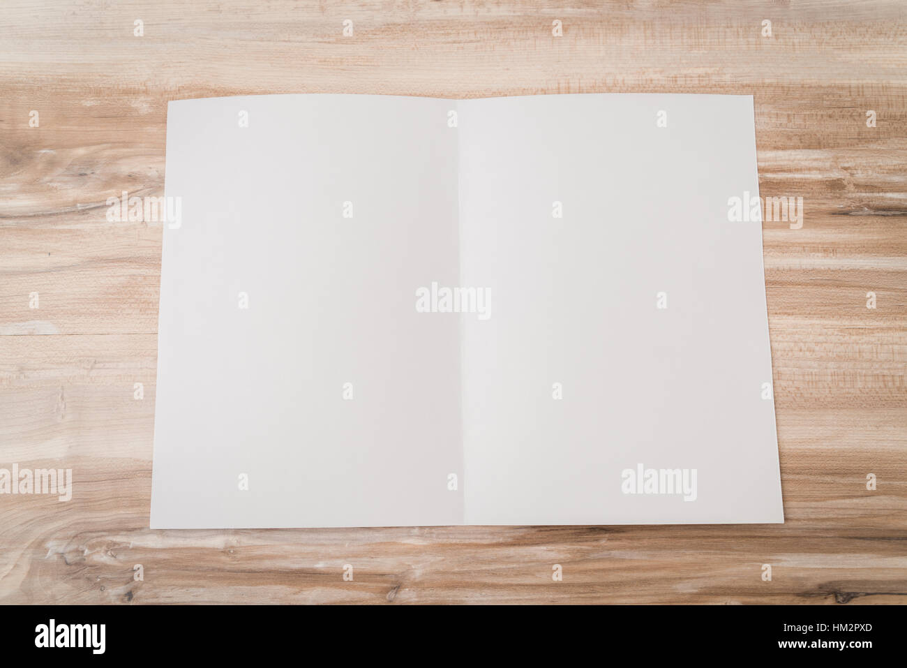 Bifold white template paper on wood texture Stock Photo - Alamy