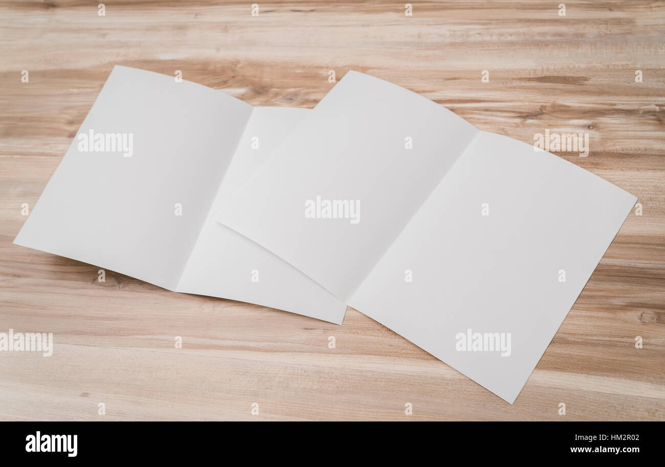 Bifold white template paper on wood texture Stock Photo - Alamy