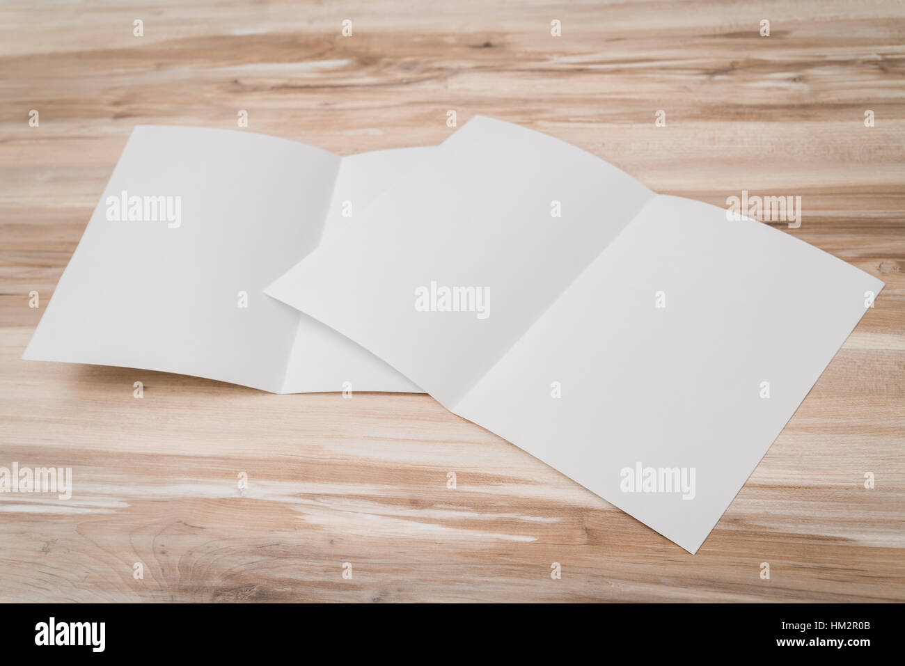 Bifold white template paper on wood texture Stock Photo - Alamy