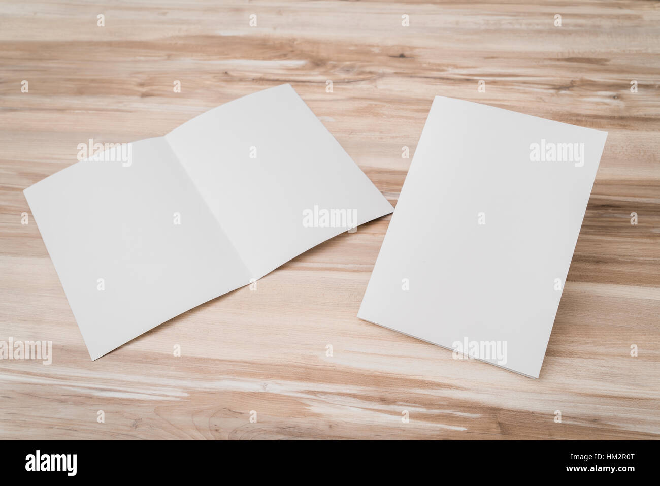 Bifold white template paper on wood texture Stock Photo - Alamy