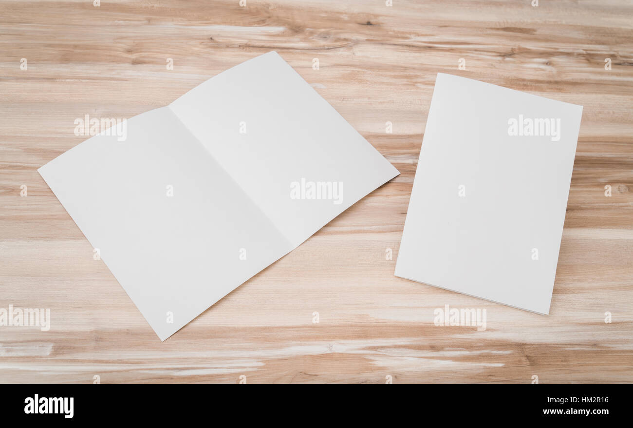 Bifold white template paper on wood texture Stock Photo - Alamy
