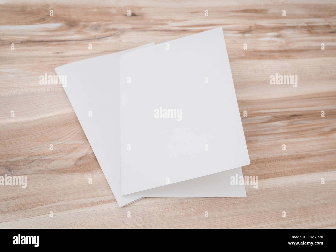 Bifold white template paper on wood texture Stock Photo - Alamy