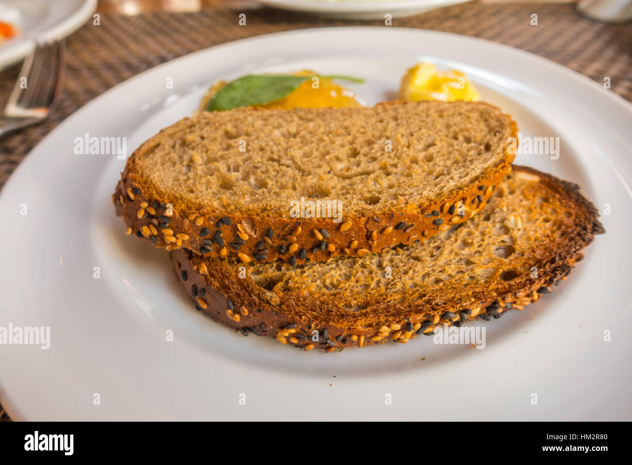 Fresh bread slice and cutting knife on table in buffet Stock Photo - Alamy