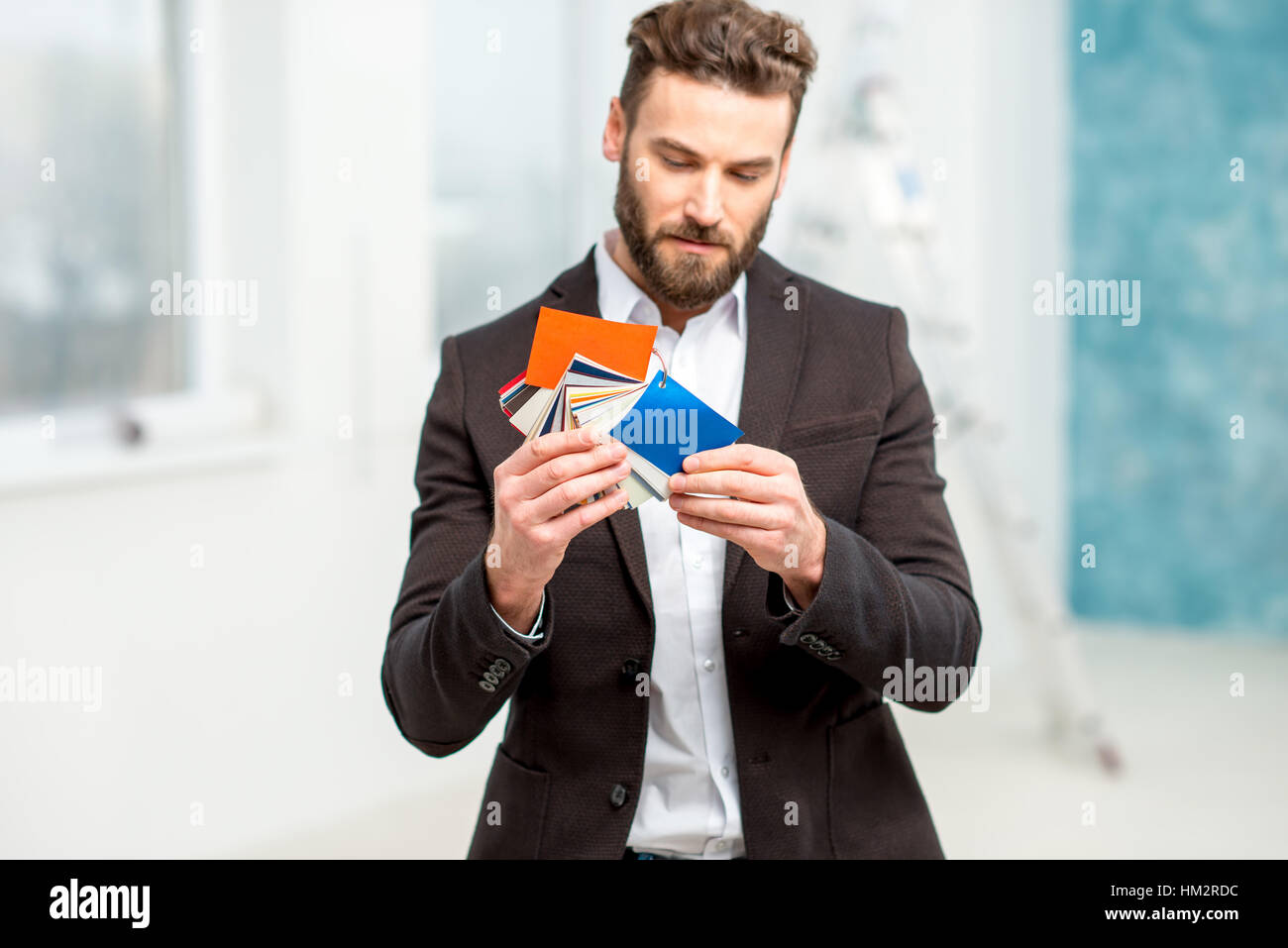 Elegant architect or designer choosing color for painting walls or ...