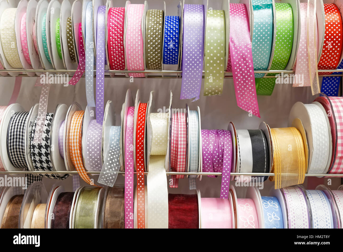 various colorful gift ribbon rolls on rack Stock Photo - Alamy
