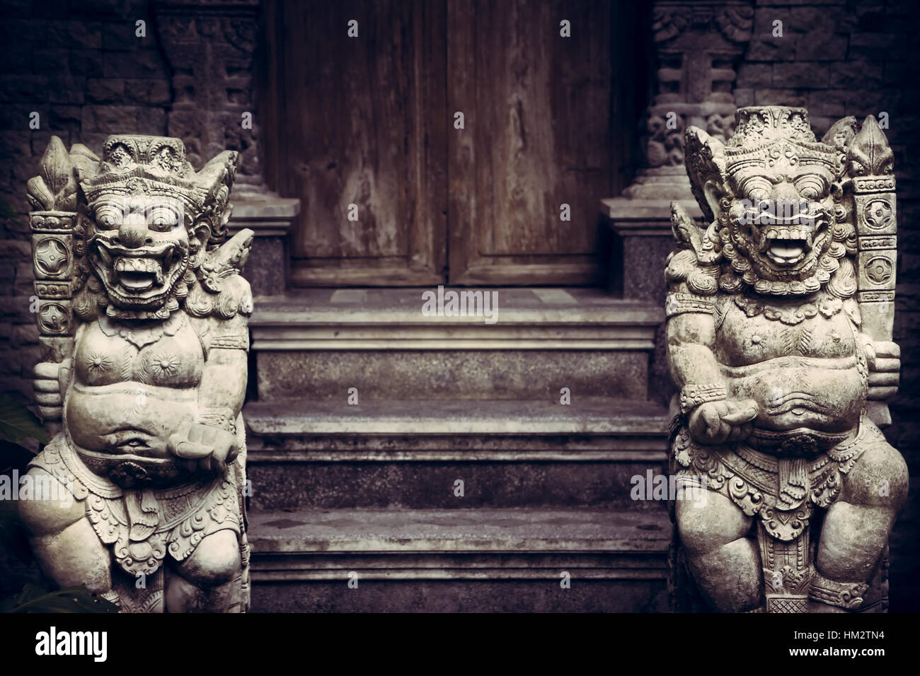 Ancient Asian demons deities at the enter to the old temple with old ...