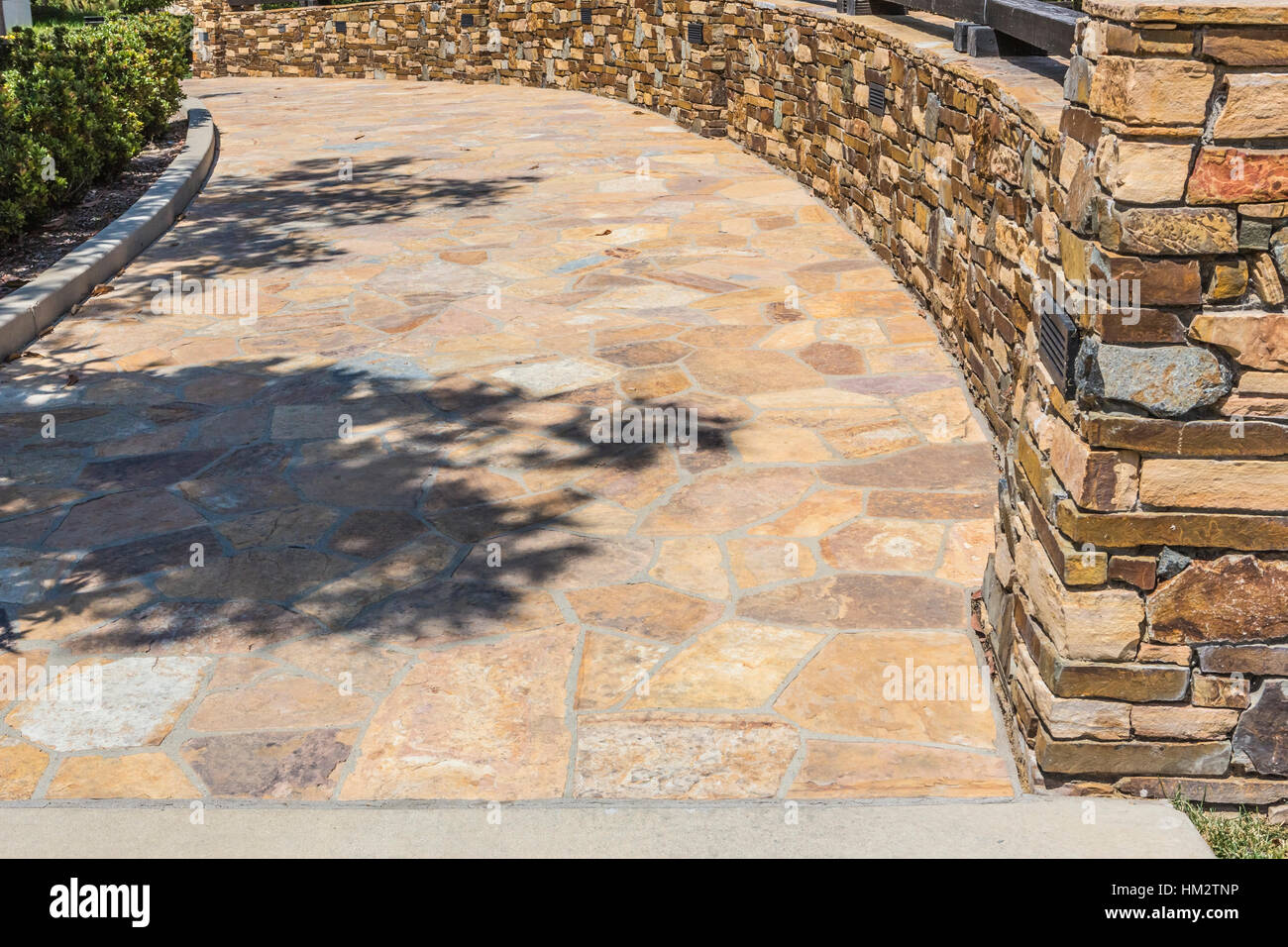 colorful path and stone wall with trees Stock Photo - Alamy