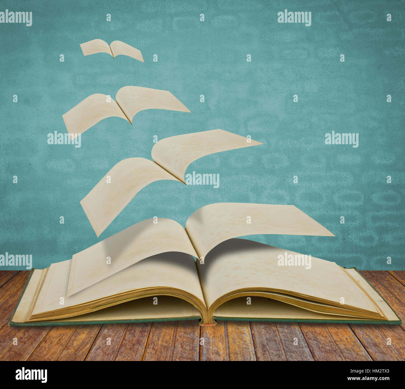 Open flying old books Stock Photo - Alamy