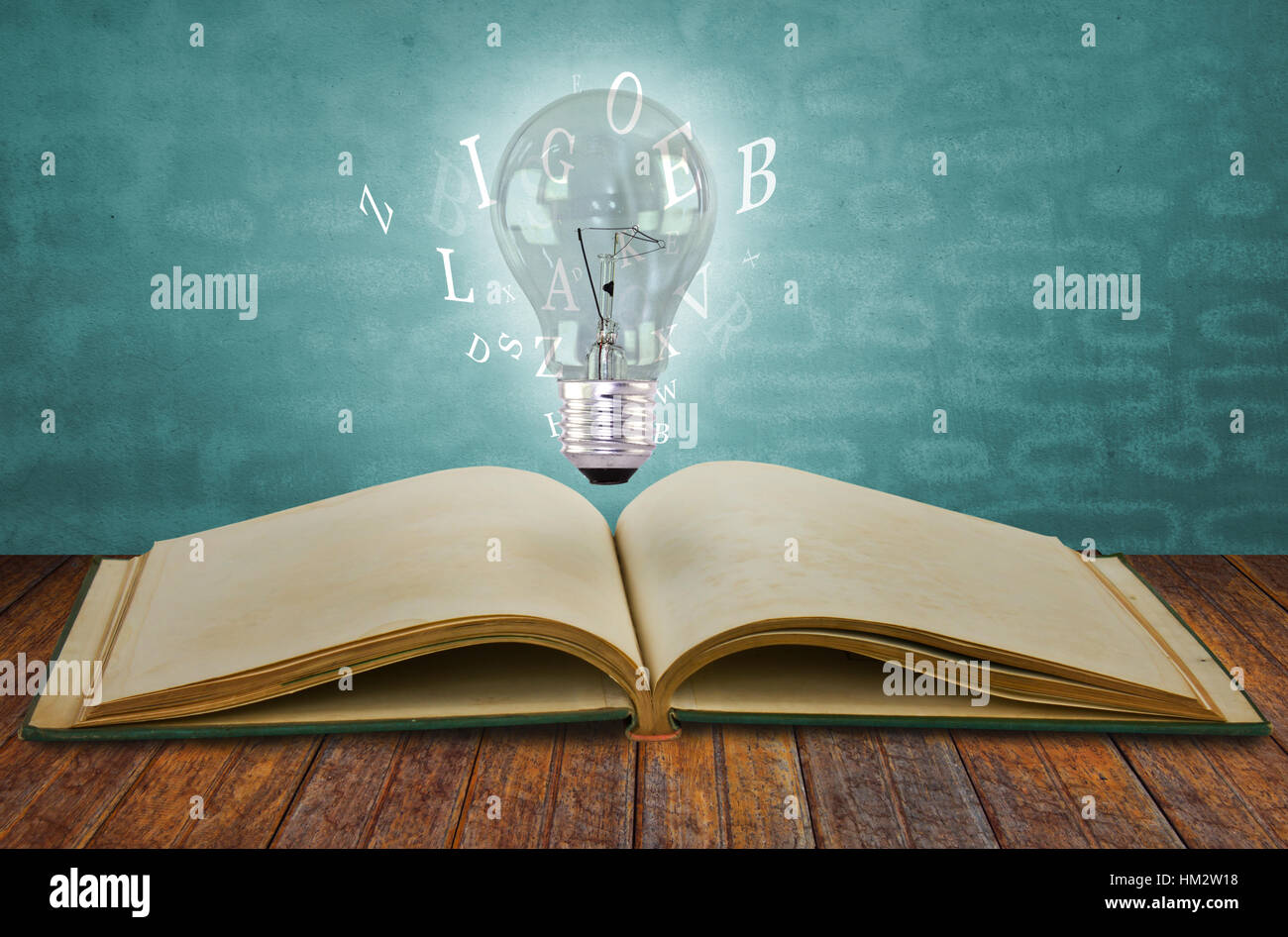 Book and light bulb Stock Photo - Alamy