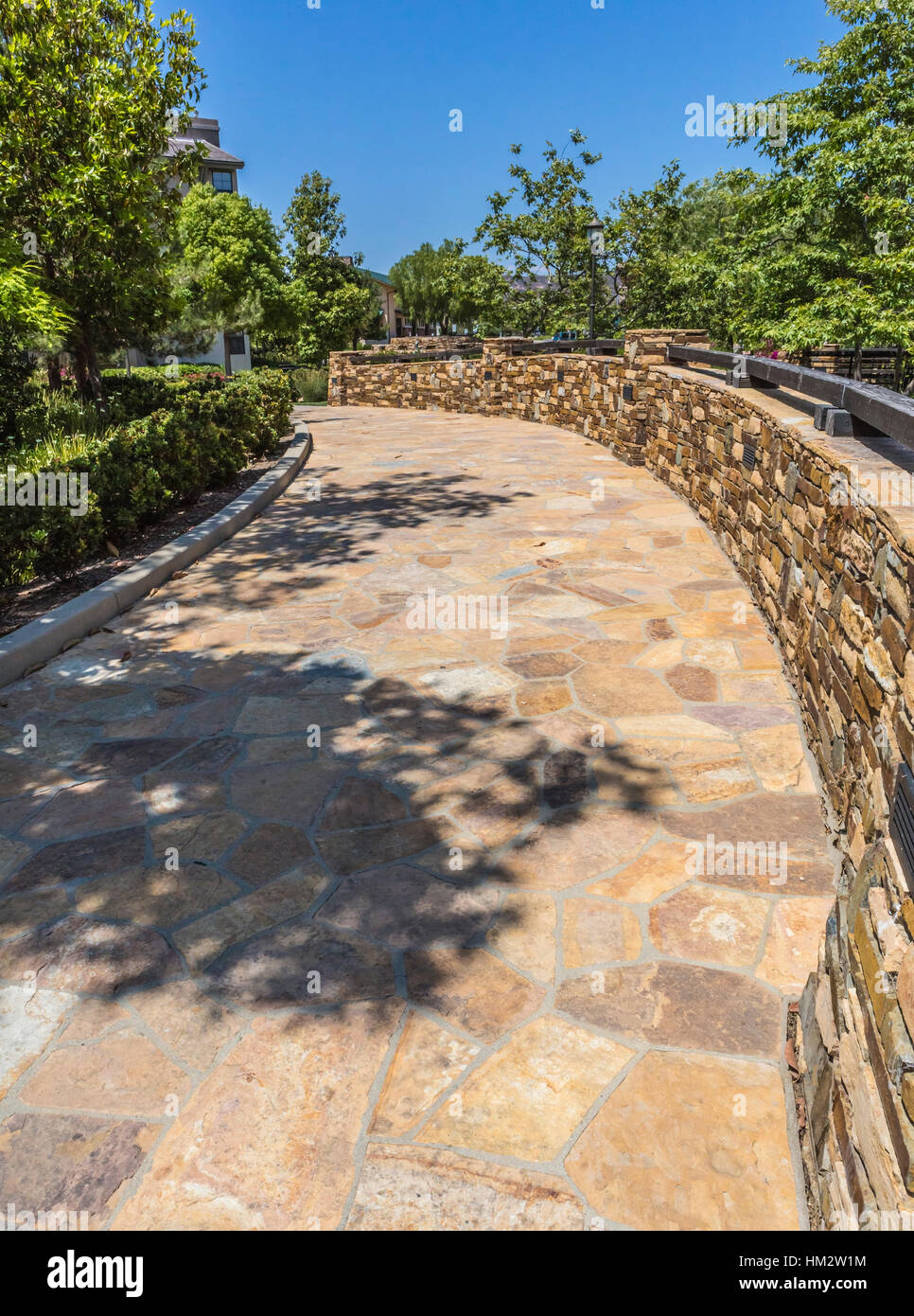 colorful path and stone wall with trees Stock Photo - Alamy