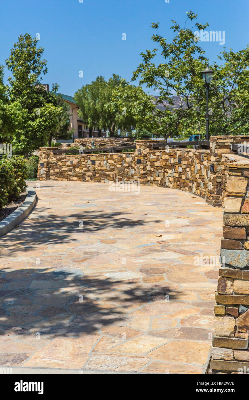 colorful path and stone wall with trees Stock Photo - Alamy