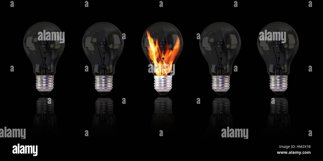 light bulb with fire on black background Stock Photo - Alamy