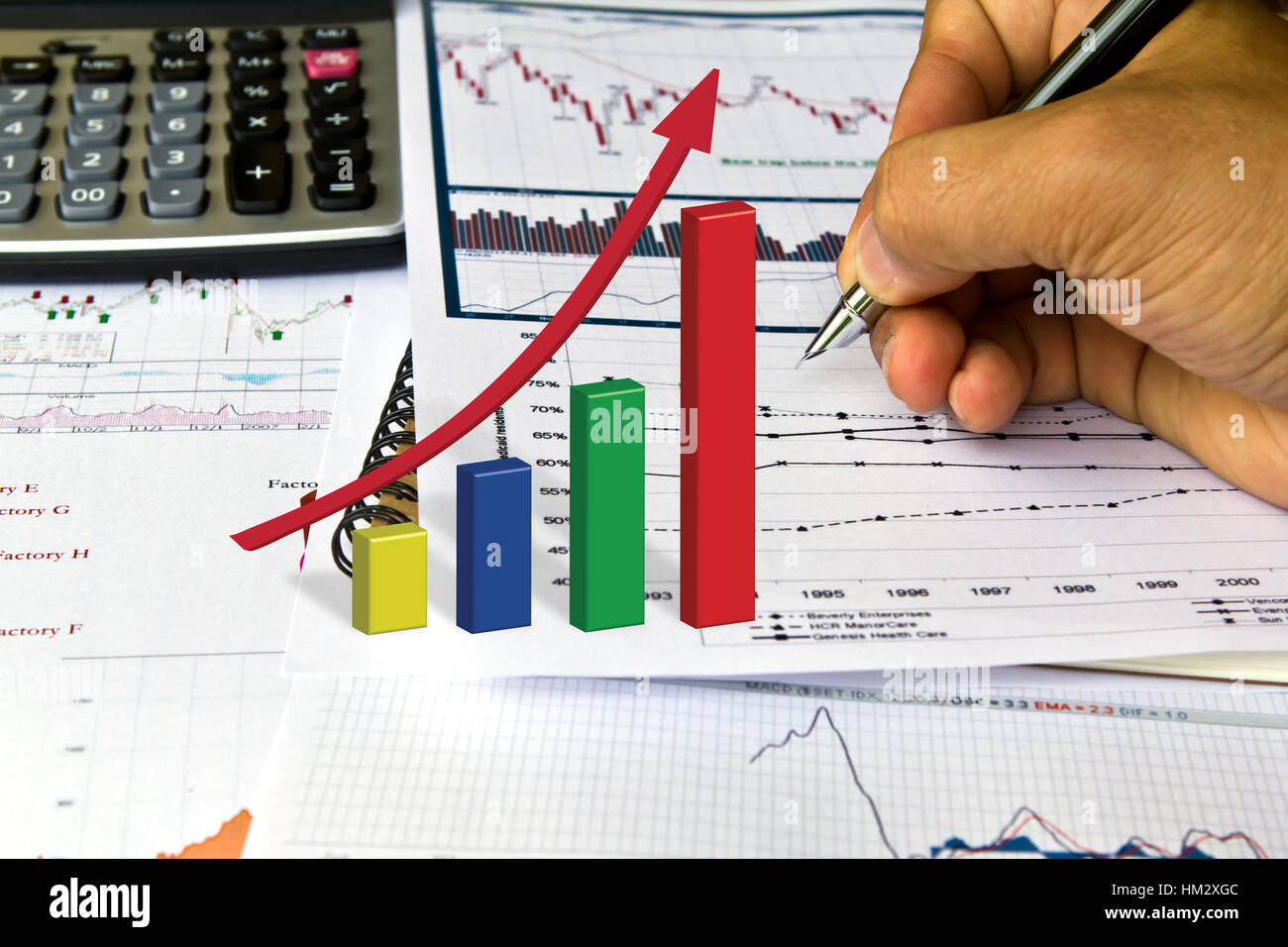 Hand write on Various financial charts on the table with calculator ...