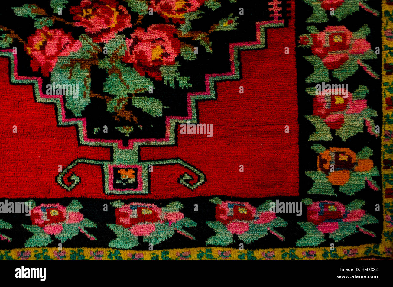 The lower corner of the Armenian carpet with red roses Stock Photo - Alamy