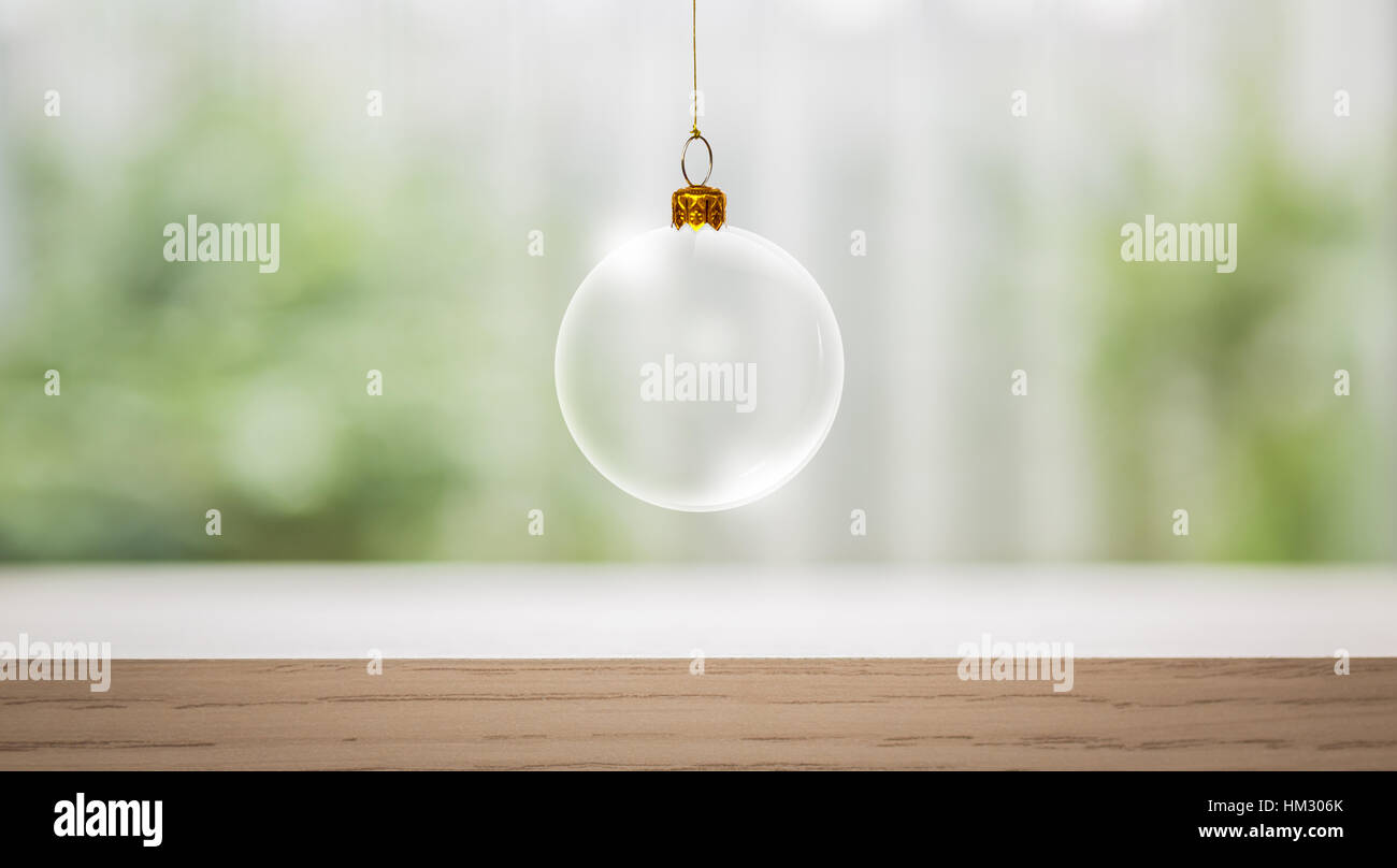 Transparent Christmas ball over wood table Stock Photo - Alamy