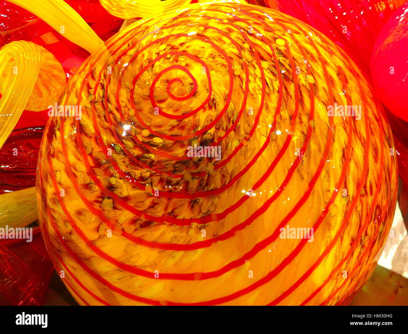 Red orange round glass sculpture created by American artist Dale ...