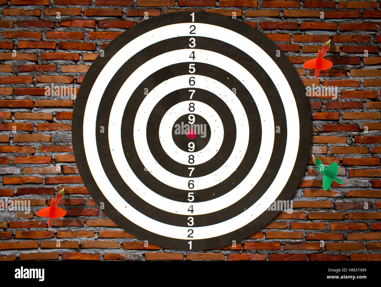 Dartboard on brick wall (Darts Hit Target Stock Photo - Alamy