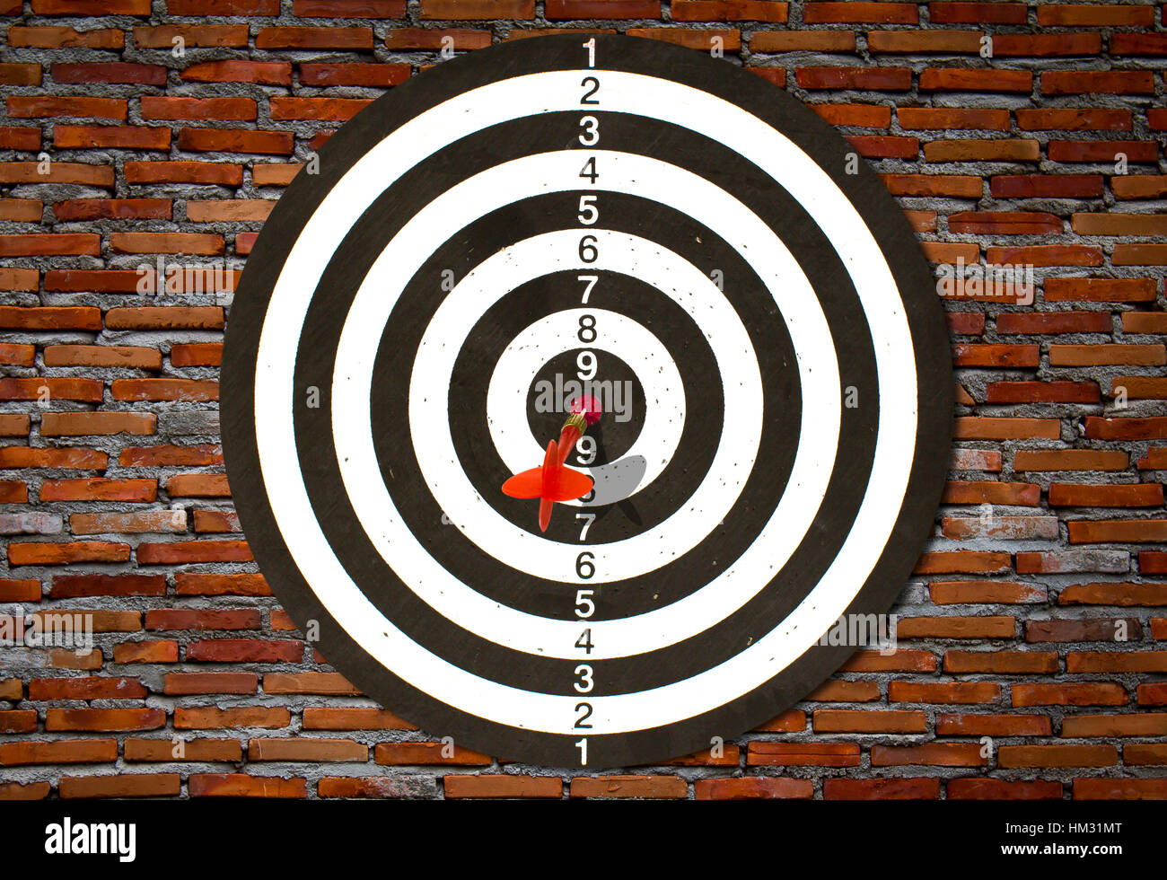 Dartboard on brick wall (Darts Hit Target Stock Photo - Alamy