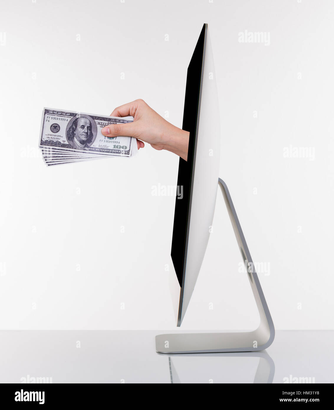 Getting money from Computer monitor Stock Photo - Alamy