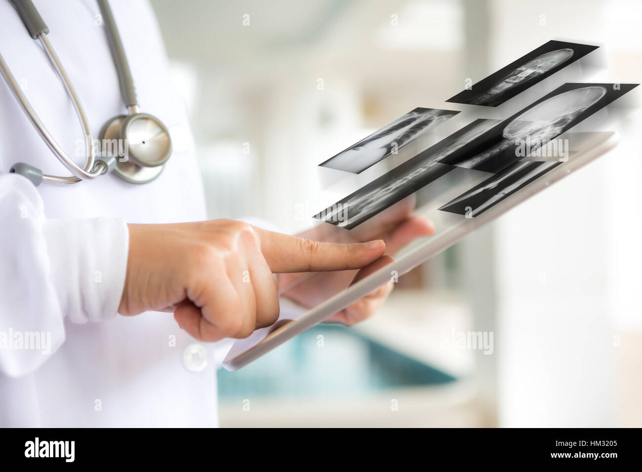 Doctor using tablet computer with screen of x-ray out Stock Photo - Alamy
