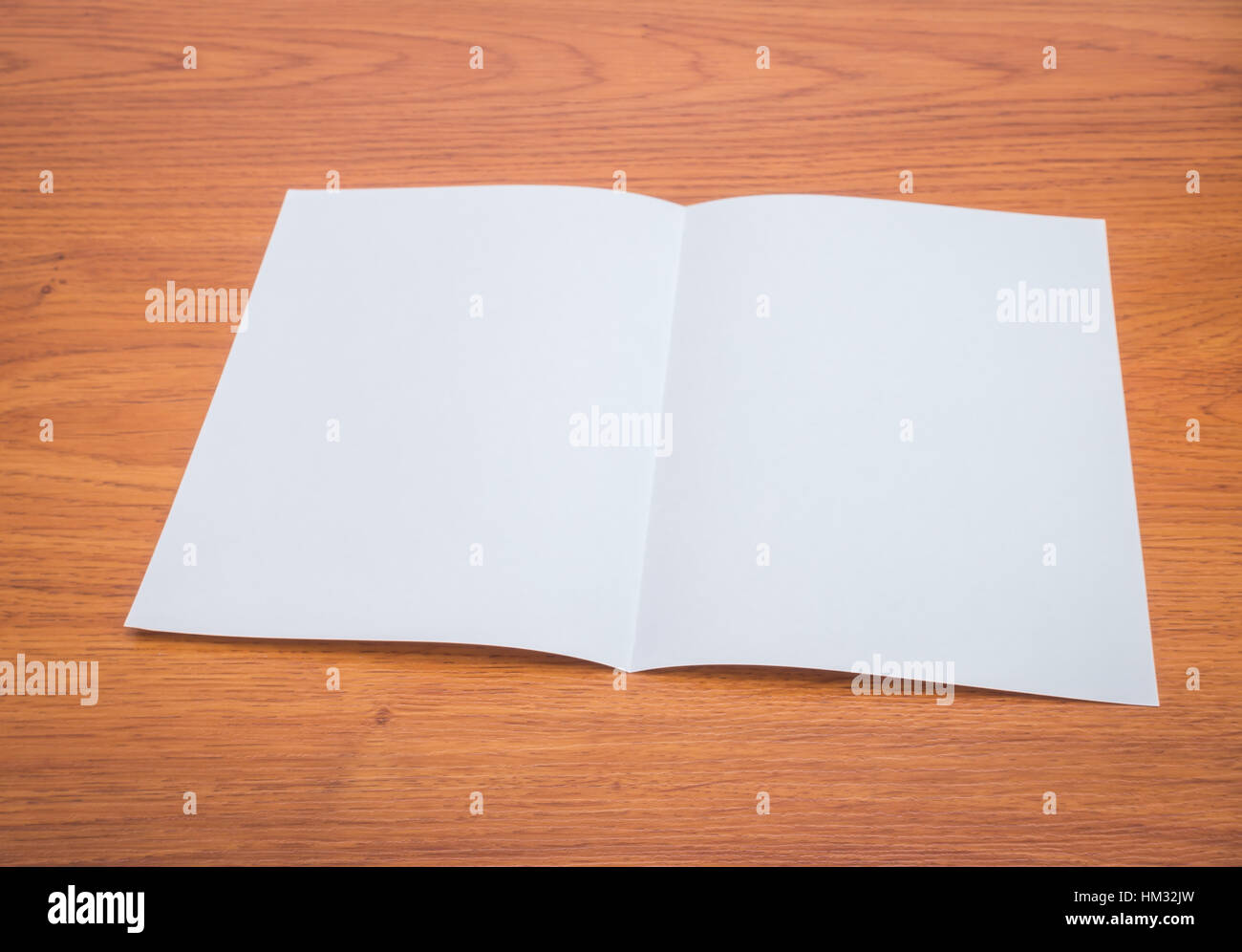 Bifold white template paper on wood texture Stock Photo - Alamy