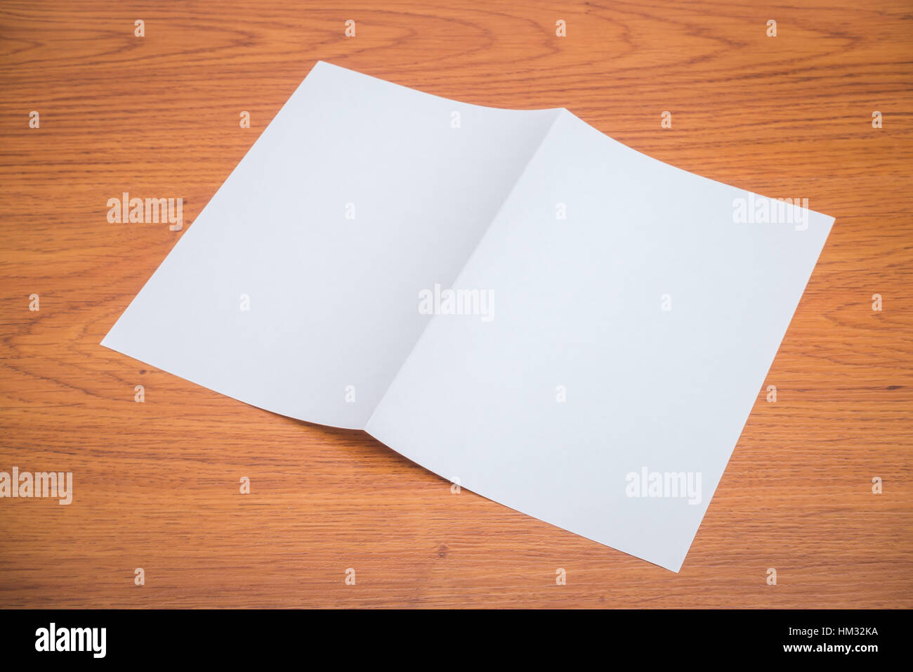 Bifold white template paper on wood texture Stock Photo - Alamy