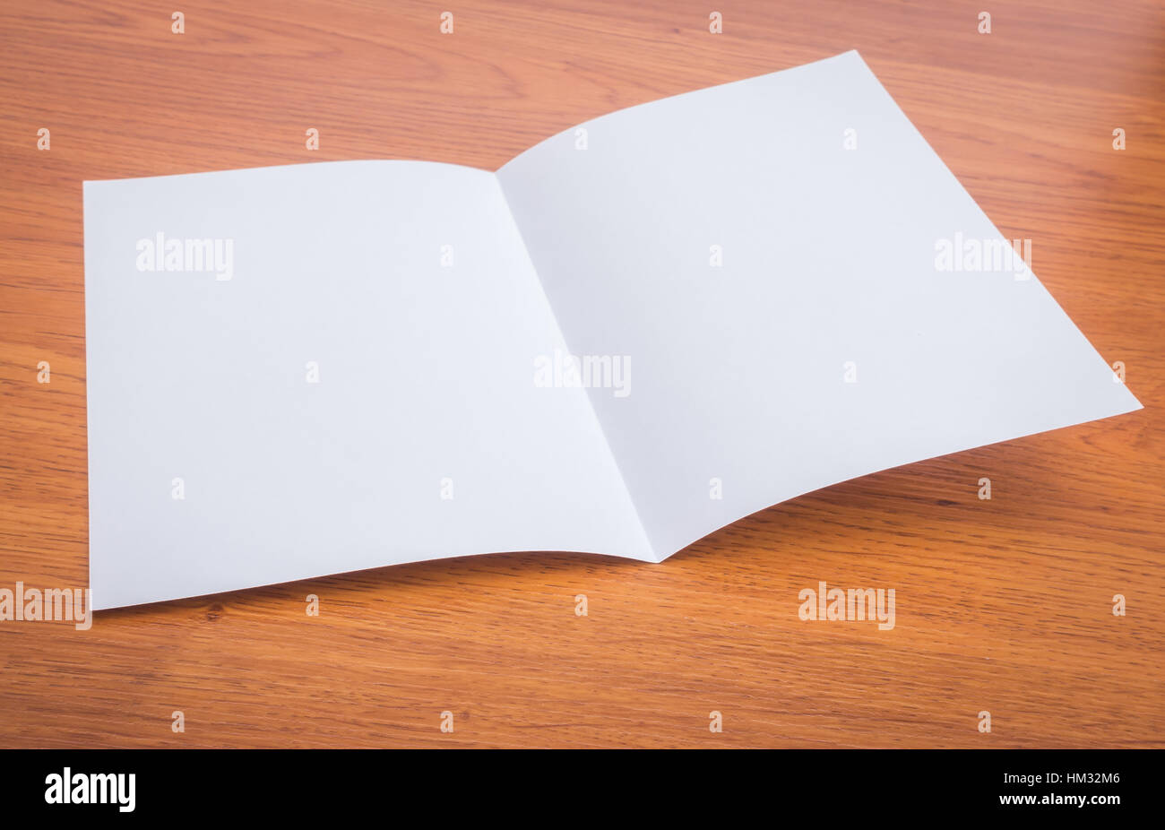 Bifold white template paper on wood texture Stock Photo - Alamy