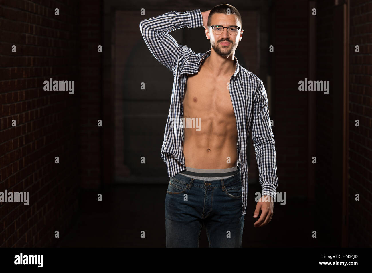 Portrait Of A Young Physically Fit Man In Jeans And T-shirt Showing His ...