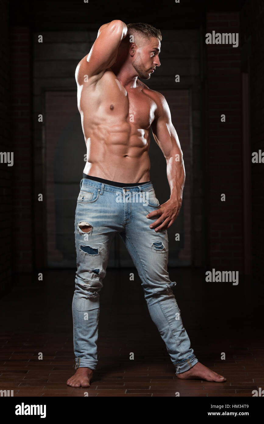Portrait Of A Young Physically Fit Man In Jeans Showing His Well ...