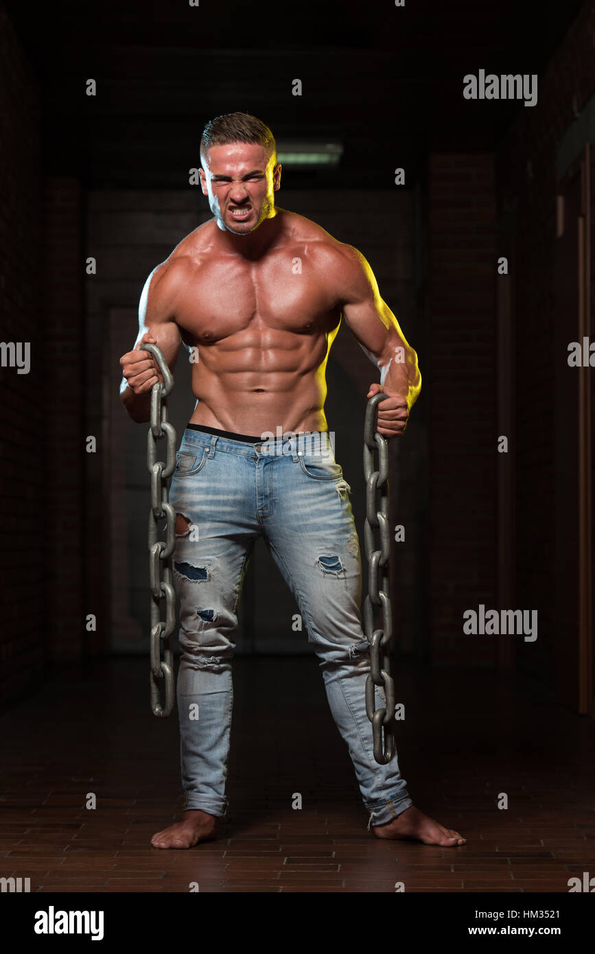 Healthy Young Bodybuilder Exercising Biceps With Chains Stock Photo - Alamy