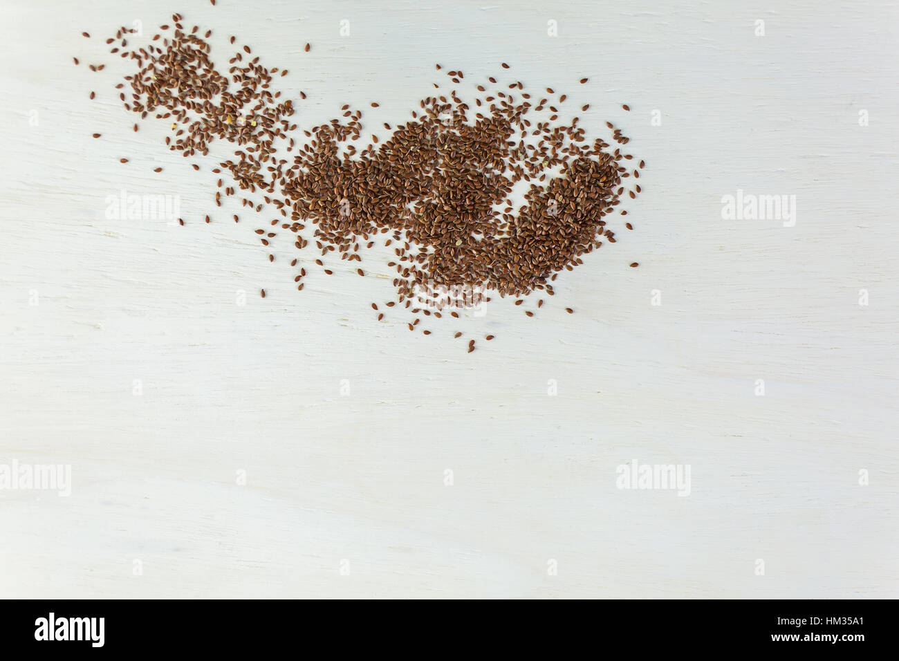 Flax seeds on painted wood board Stock Photo - Alamy