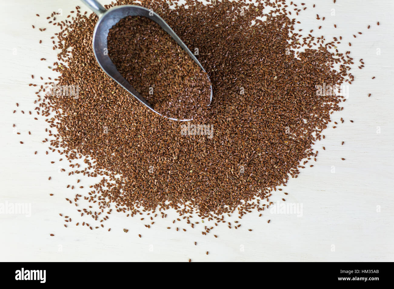 Flax seeds on painted wood board Stock Photo - Alamy