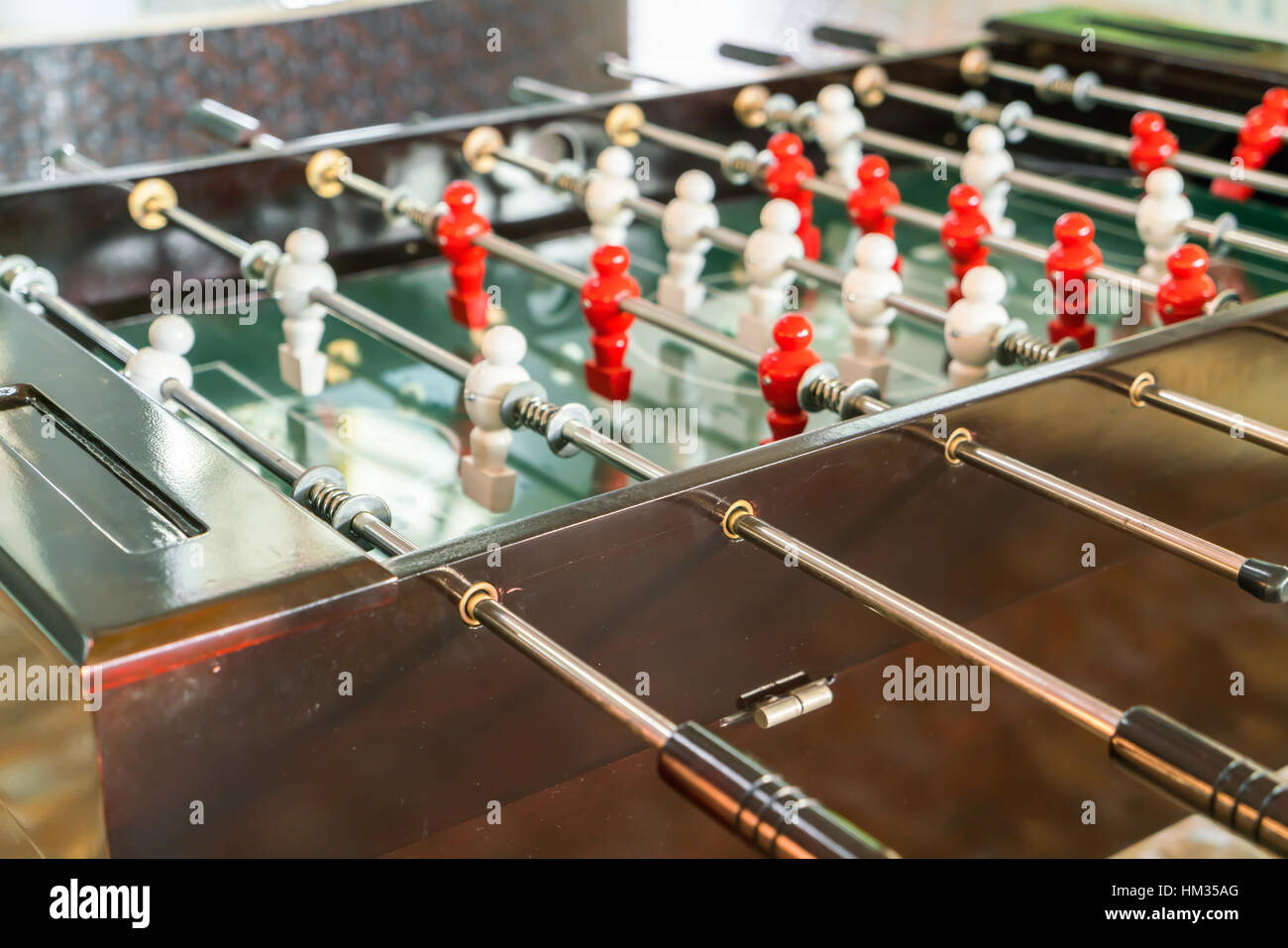 Football table game with red and white player Stock Photo - Alamy