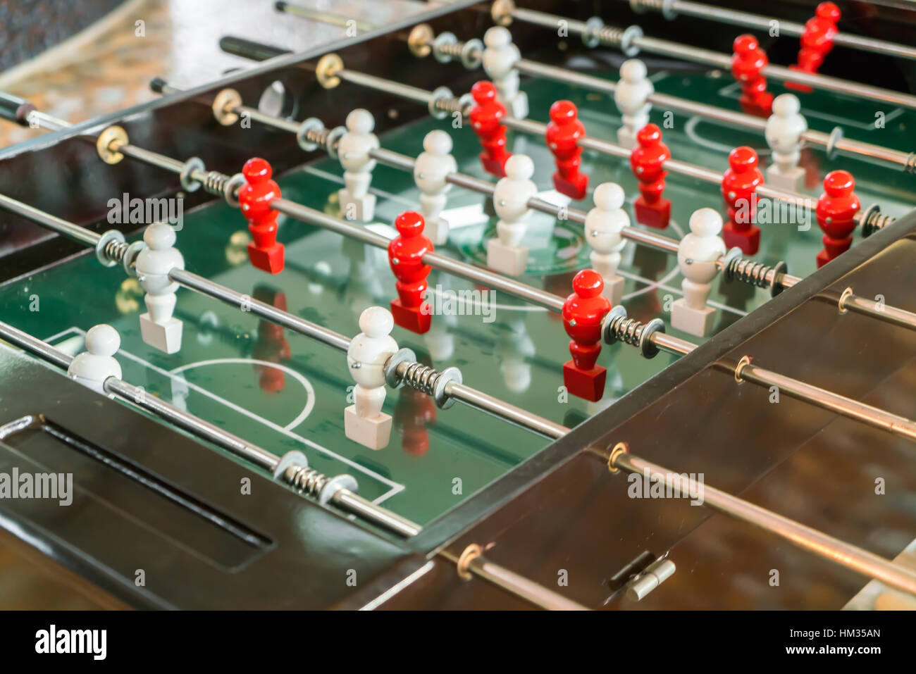 Football table game with red and white player Stock Photo - Alamy
