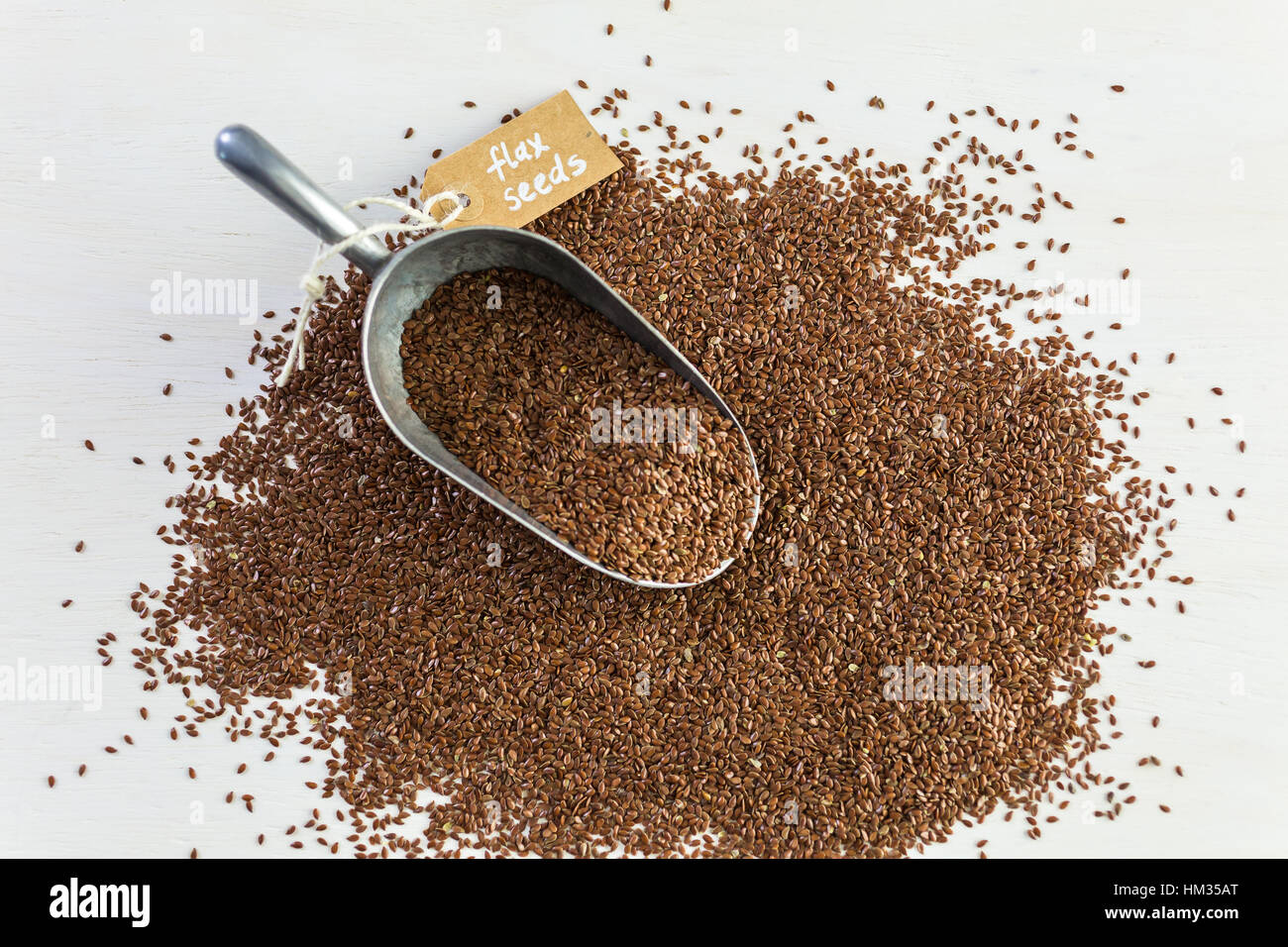 Flax seeds on painted wood board Stock Photo - Alamy