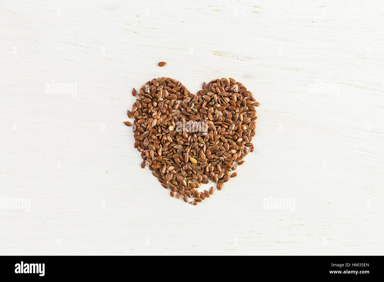 Flax seeds on painted wood board Stock Photo - Alamy